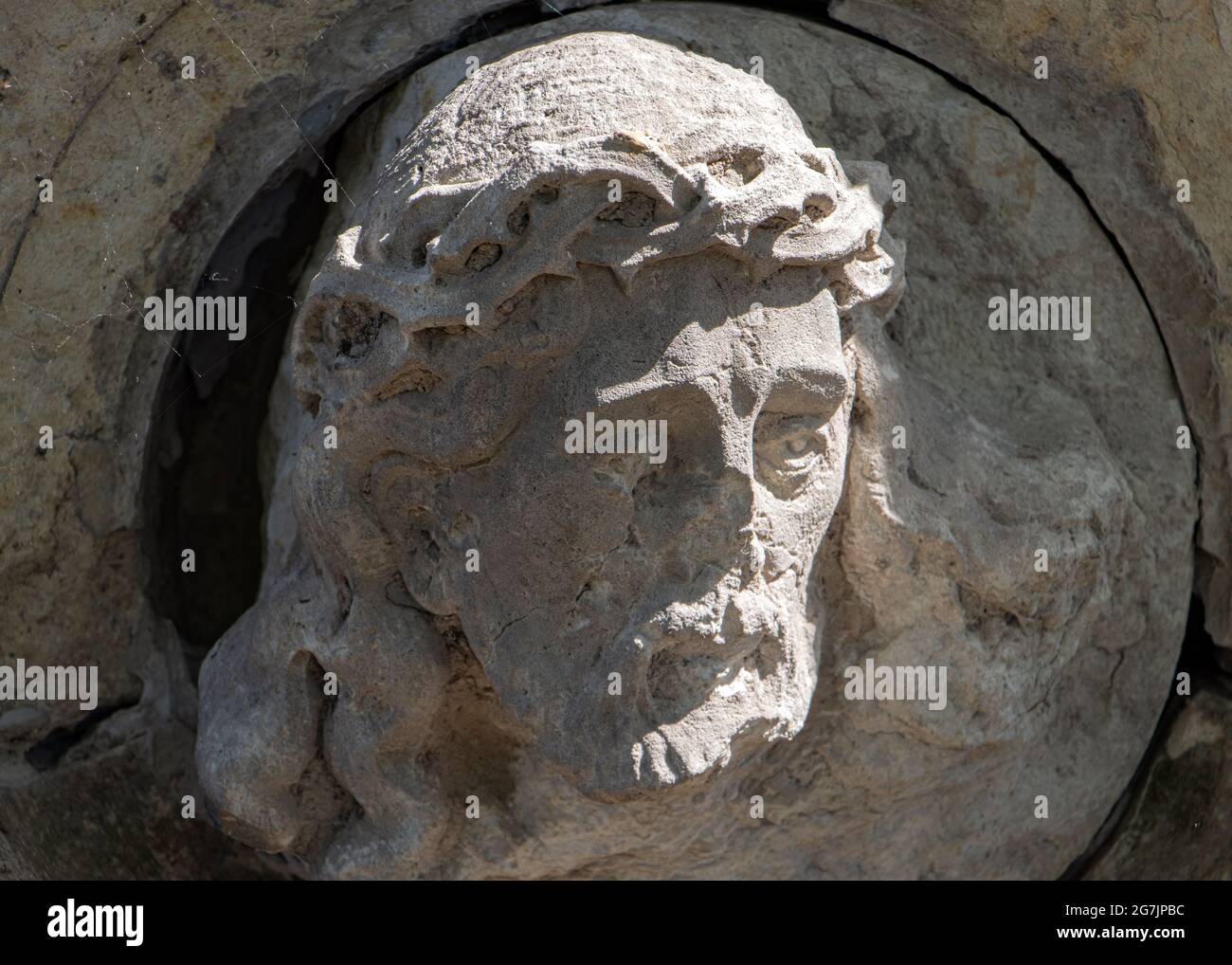 Damaged statue of Jesus Christ on a tombstone Stock Photo - Alamy