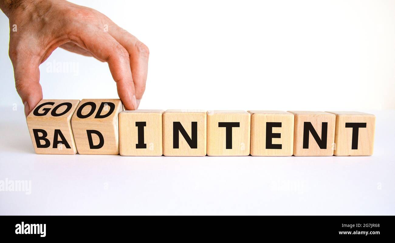 Good or bad intent symbol. Businessman turns wooden cubes and changes ...
