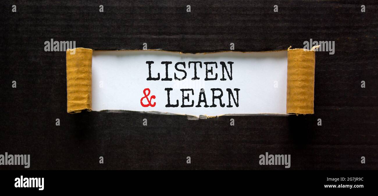 Listen and learn symbol. Words 'Listen and learn' appearing behind torn ...