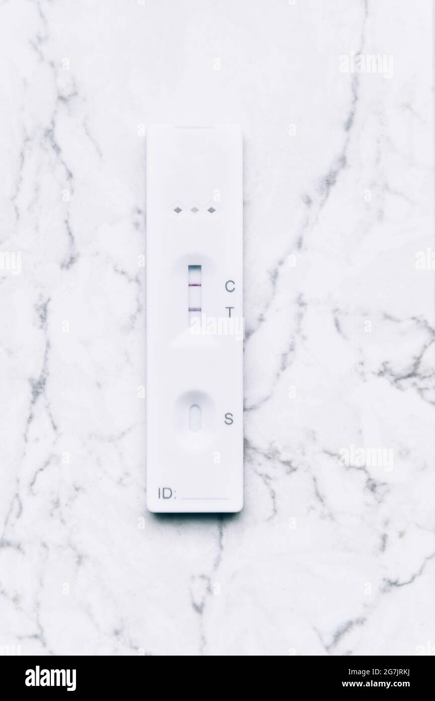 Positive rapid lateral flow coronavirus test Stock Photo - Alamy