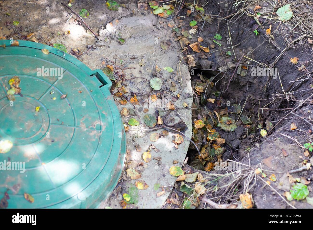 Collapsed soil near the concrete rings of an underground well ...