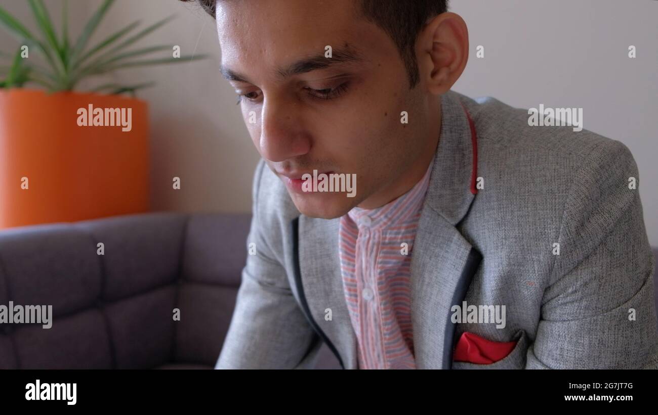 Handsome Indian man in a suit looking at some with a serious face Stock ...