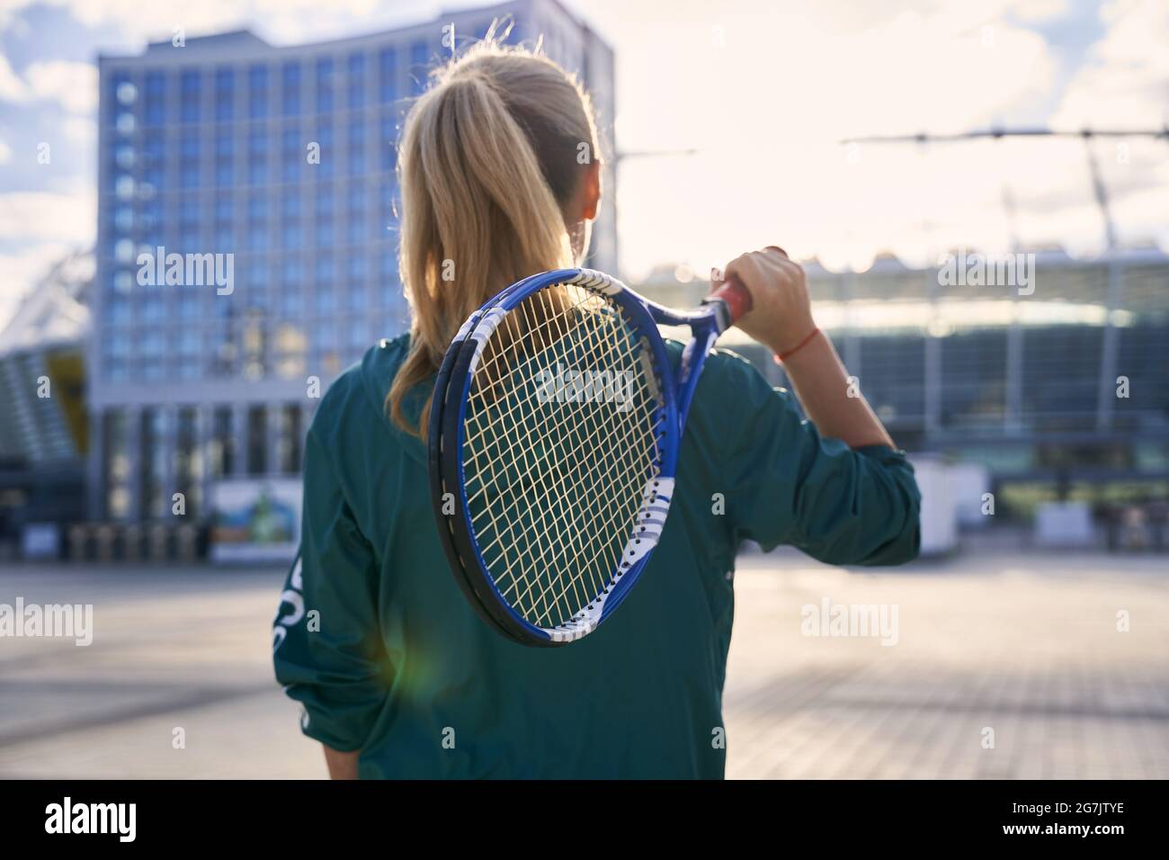 Back view of middle aged sportswoman, professional tennis player ...
