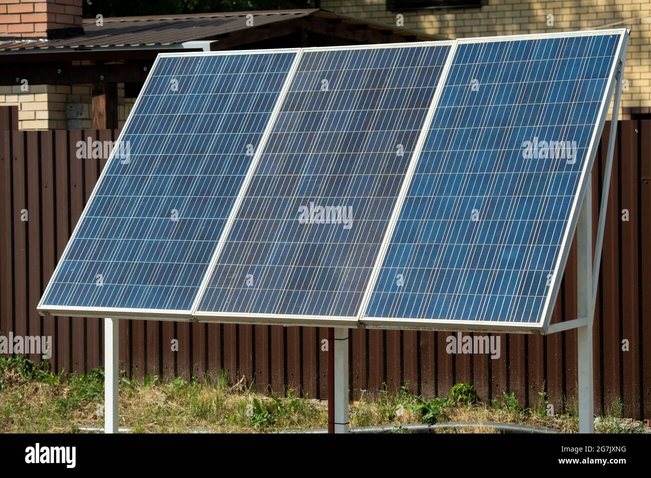 Photovoltaic panels facily in backyard of house, green energy concept ...