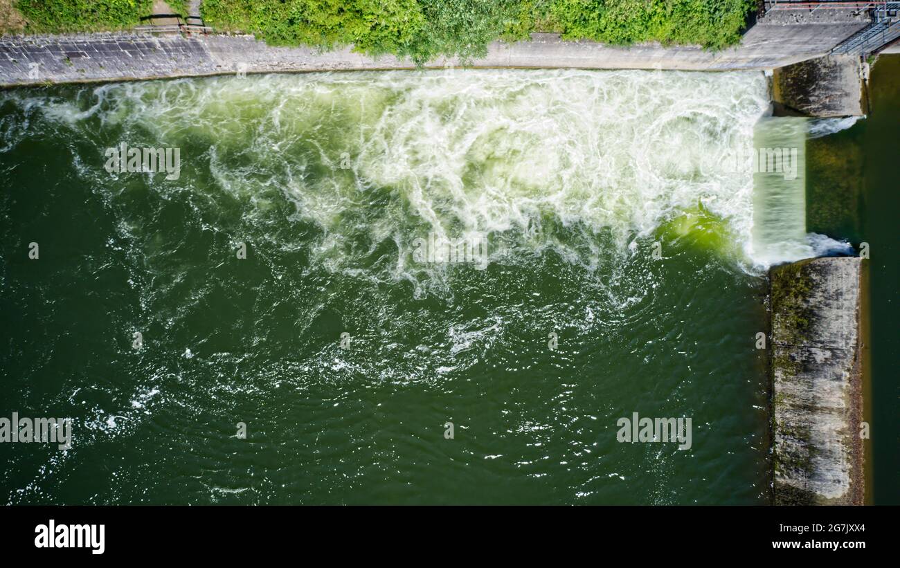 Small dam on a green flowing river Stock Photo - Alamy
