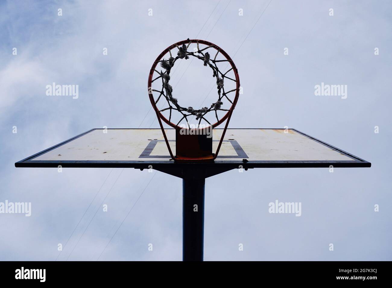 Low angle shot of a basketball hoop under a cloudy sky Stock Photo - Alamy