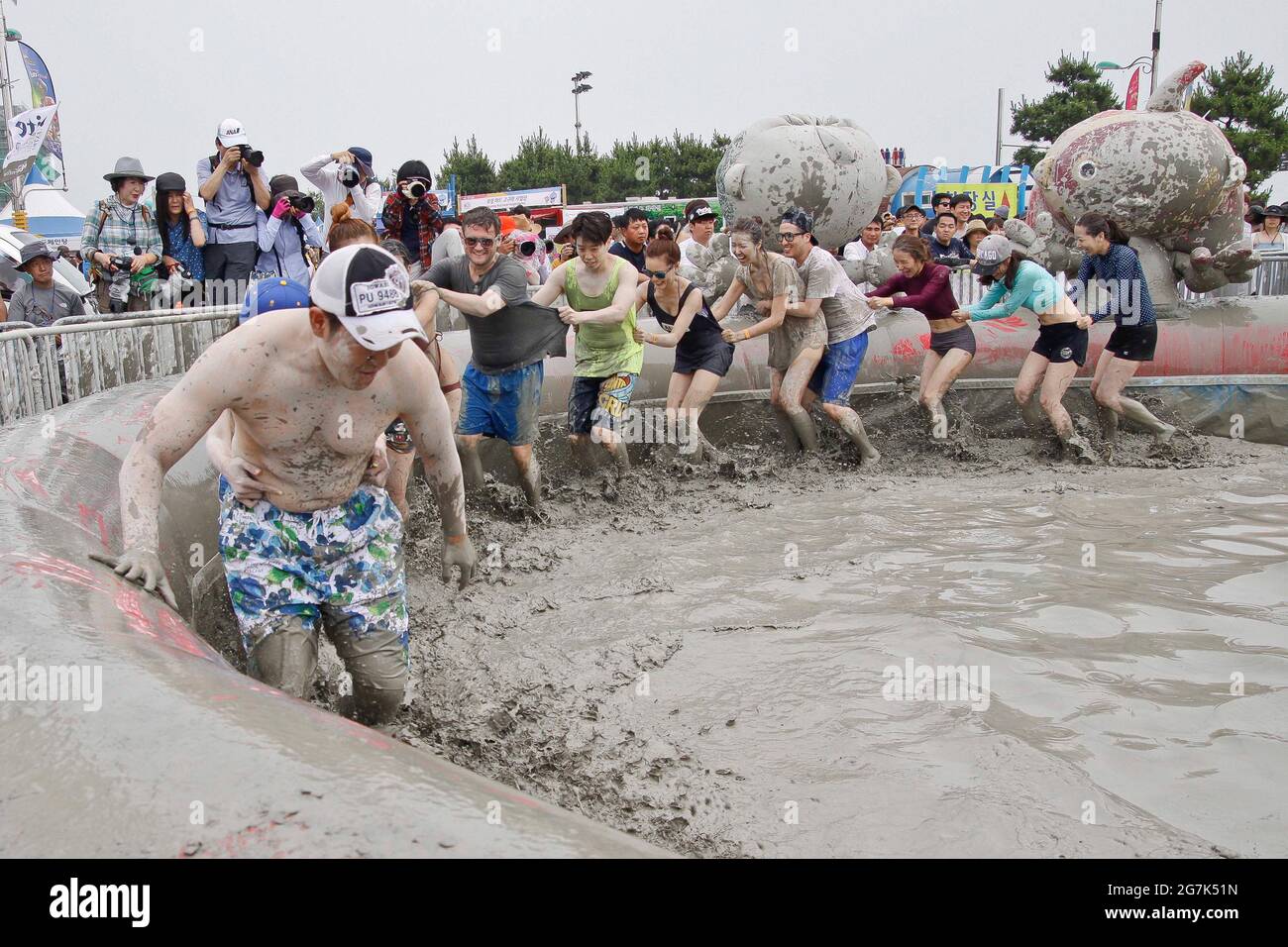 July 15, 2021-Boryeong, South Korea-A Visitors enjoying wrestle in the mud pool during an Annual ...