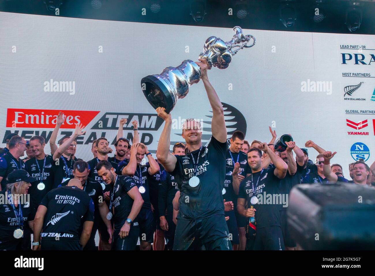 Emirates Team New Zealand (NZ) Steven Ferguson holding the cup, and his ...