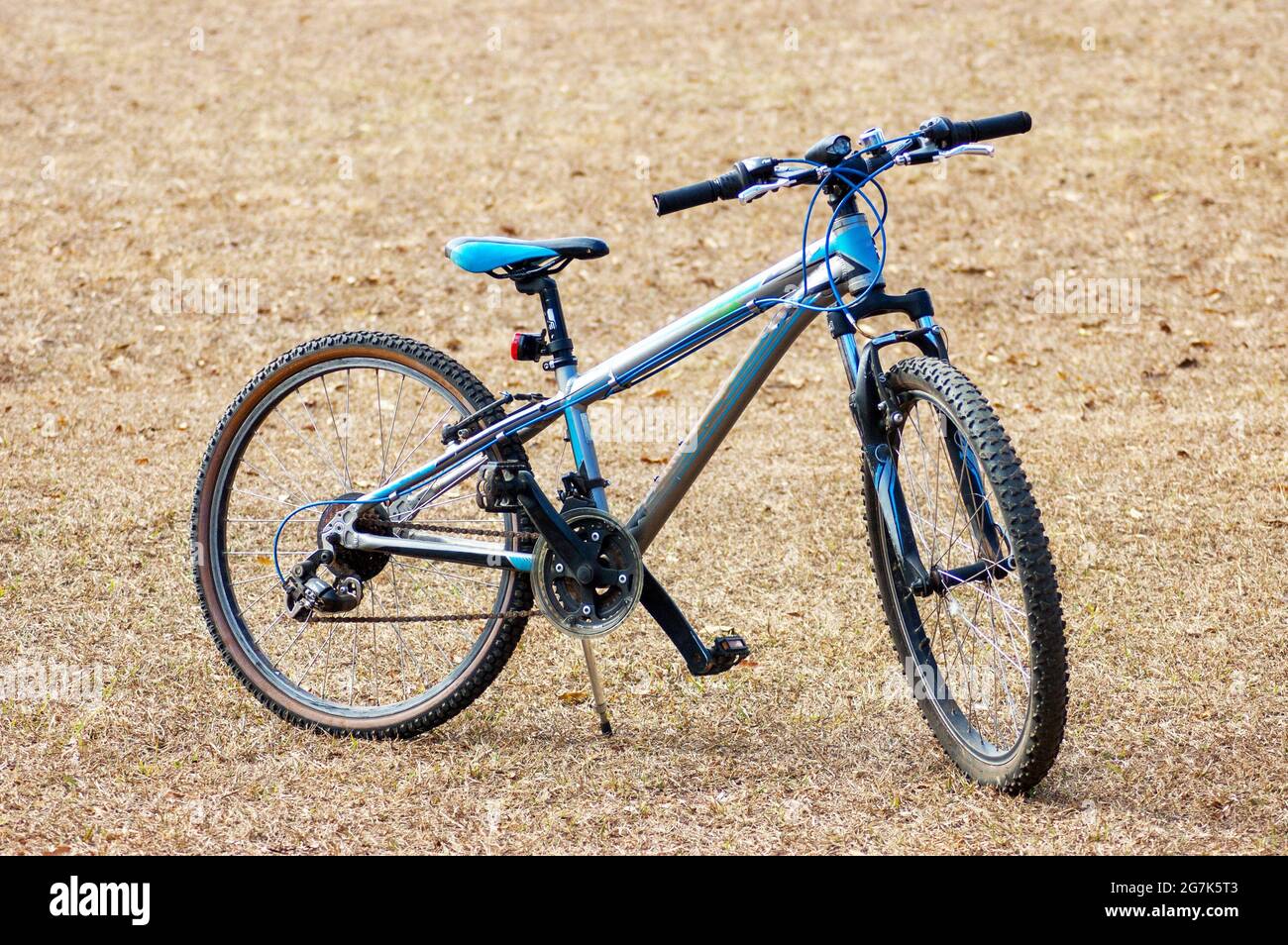 Blue generic bicycle in an open field during daylight Stock Photo - Alamy