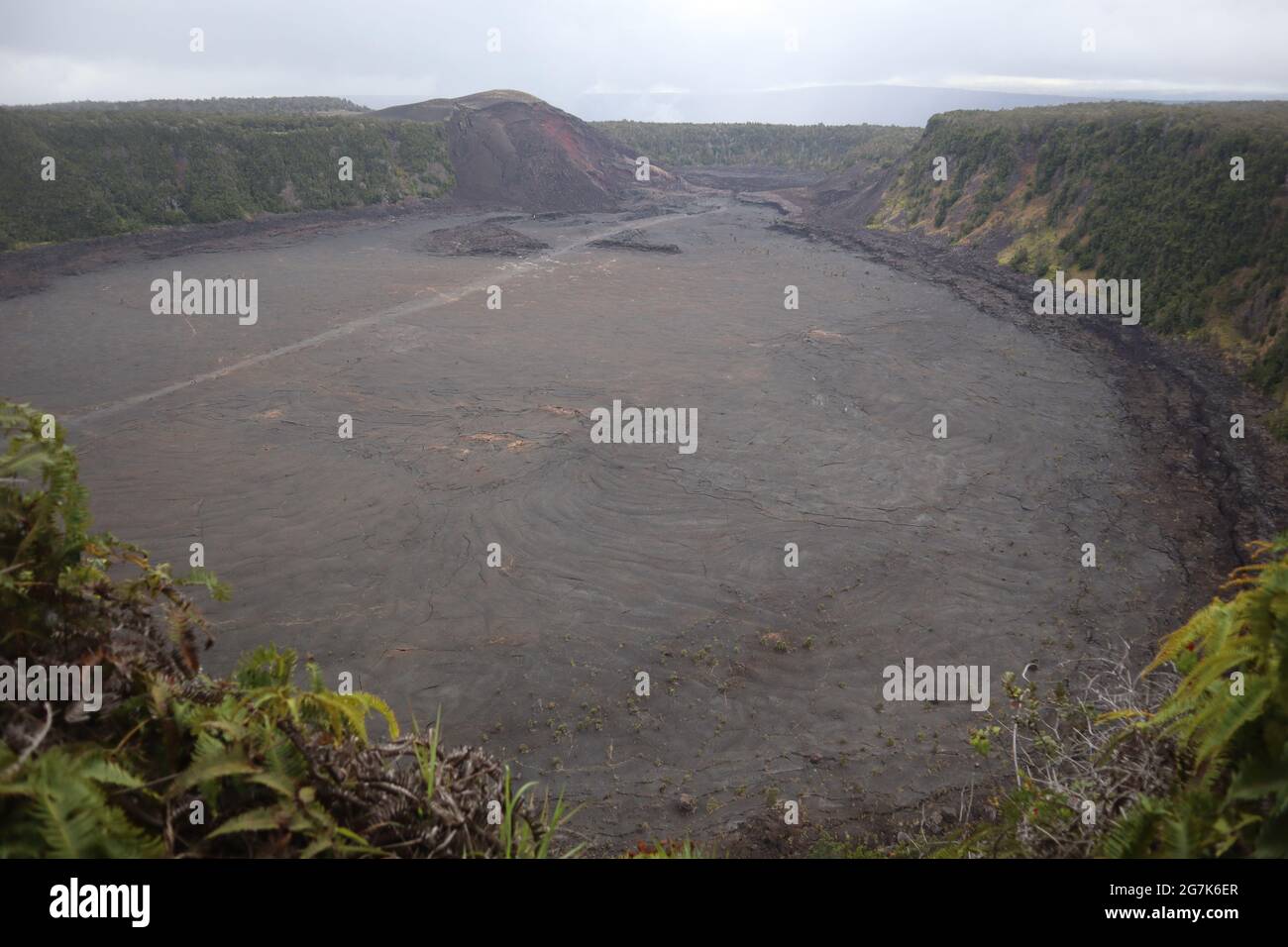 Landscape of a crater with a large active volcano with rising steam ...