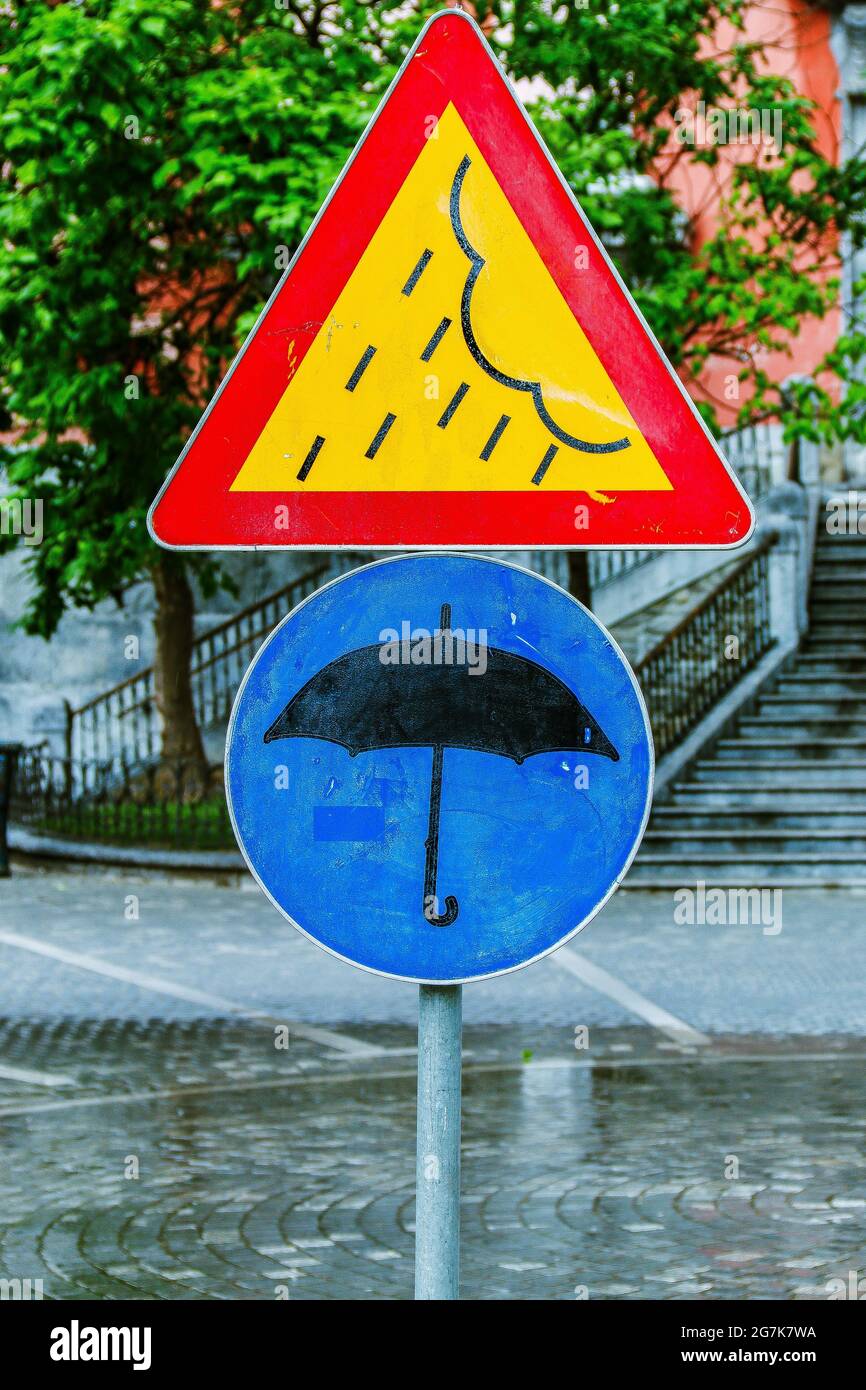 Warning sign of artificial rain on the sidewalk Stock Photo - Alamy