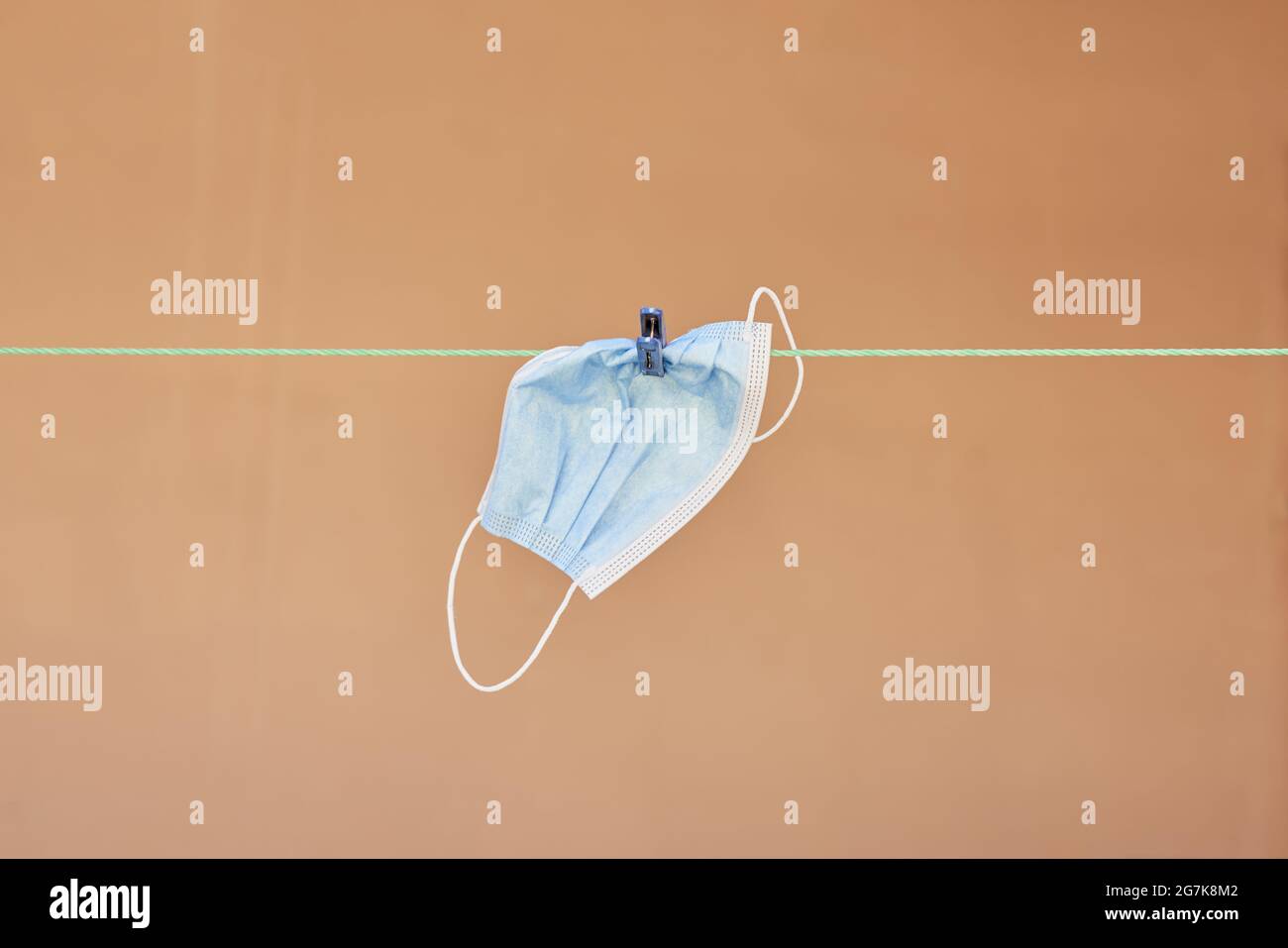 Medical disposable face mask hanging on the rope Stock Photo - Alamy