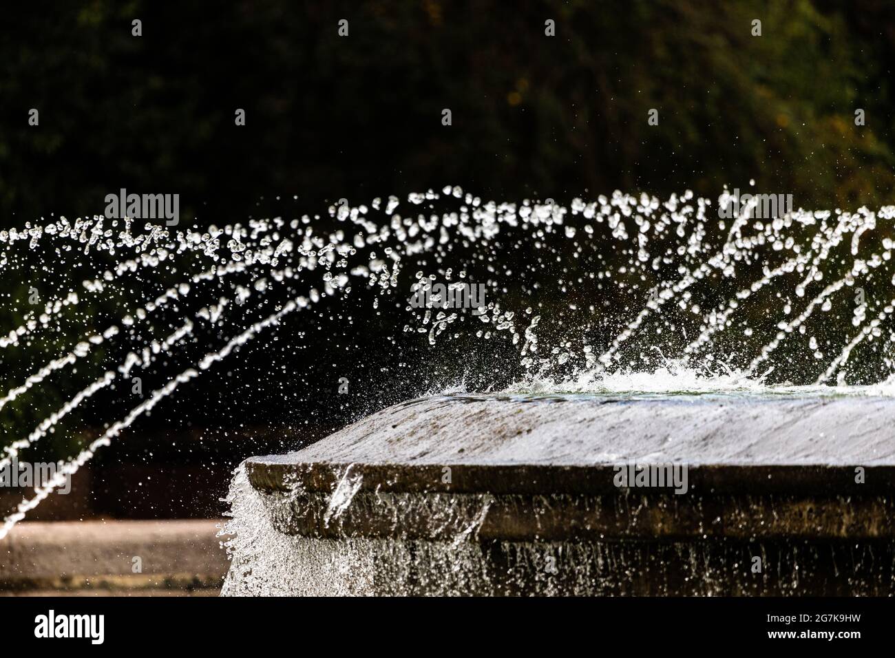Fountain splashing water in a park Stock Photo - Alamy
