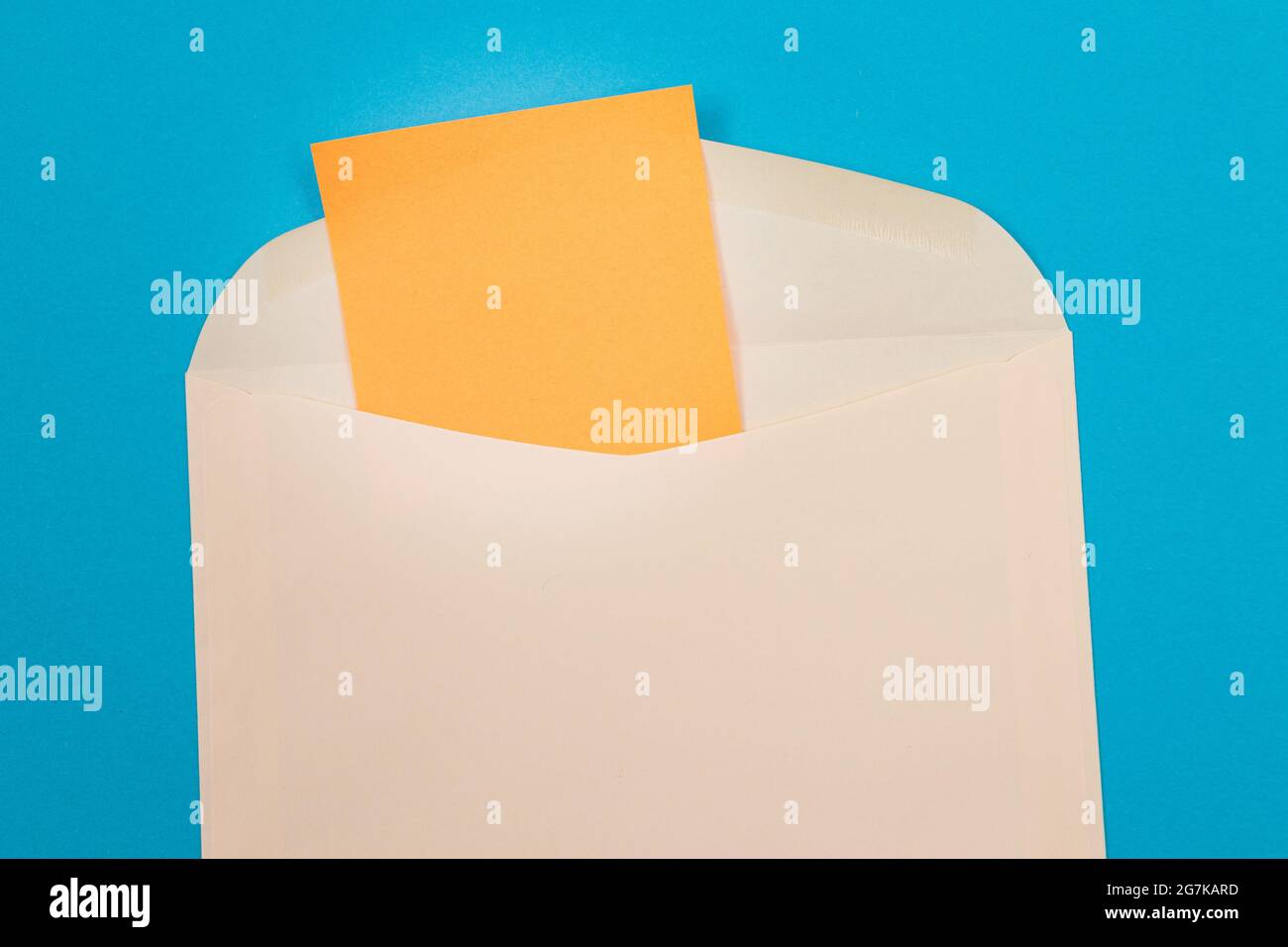 Beige Envelope with Blank Orange Sheet of Paper Inside, Lying on Blue ...