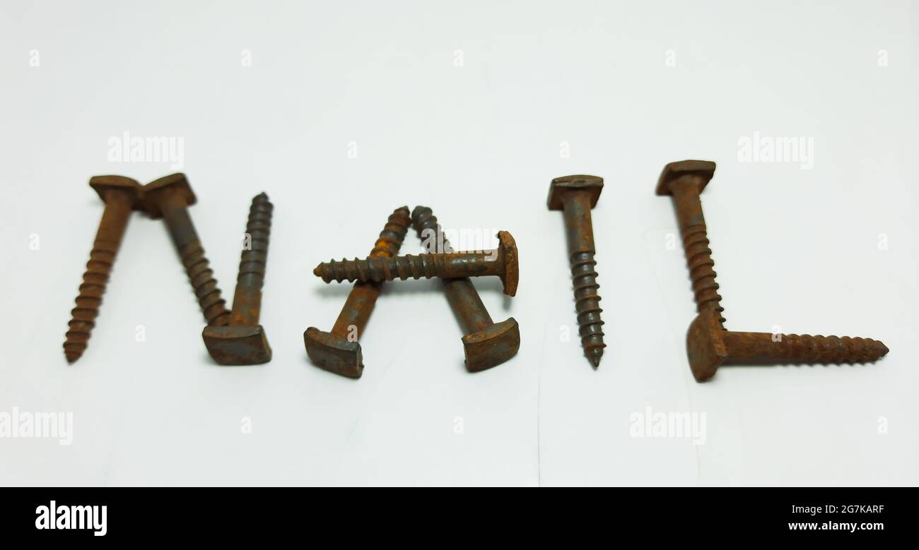 Group of rusty iron nails forming the word " NAIL Stock Photo - Alamy