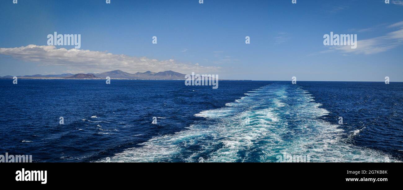 Panoramic view of the wavy beautiful sea gleaming under the cloudy blue ...