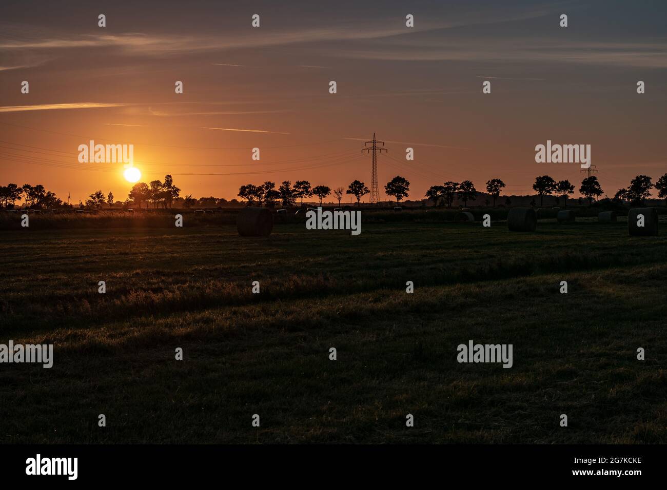 View of the sun setting down over the peaceful countryside Stock Photo ...