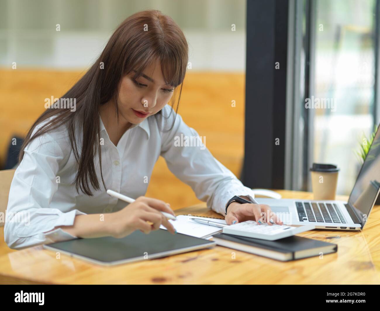 Hard work businesswoman analysing financial income, tablet, laptop ...