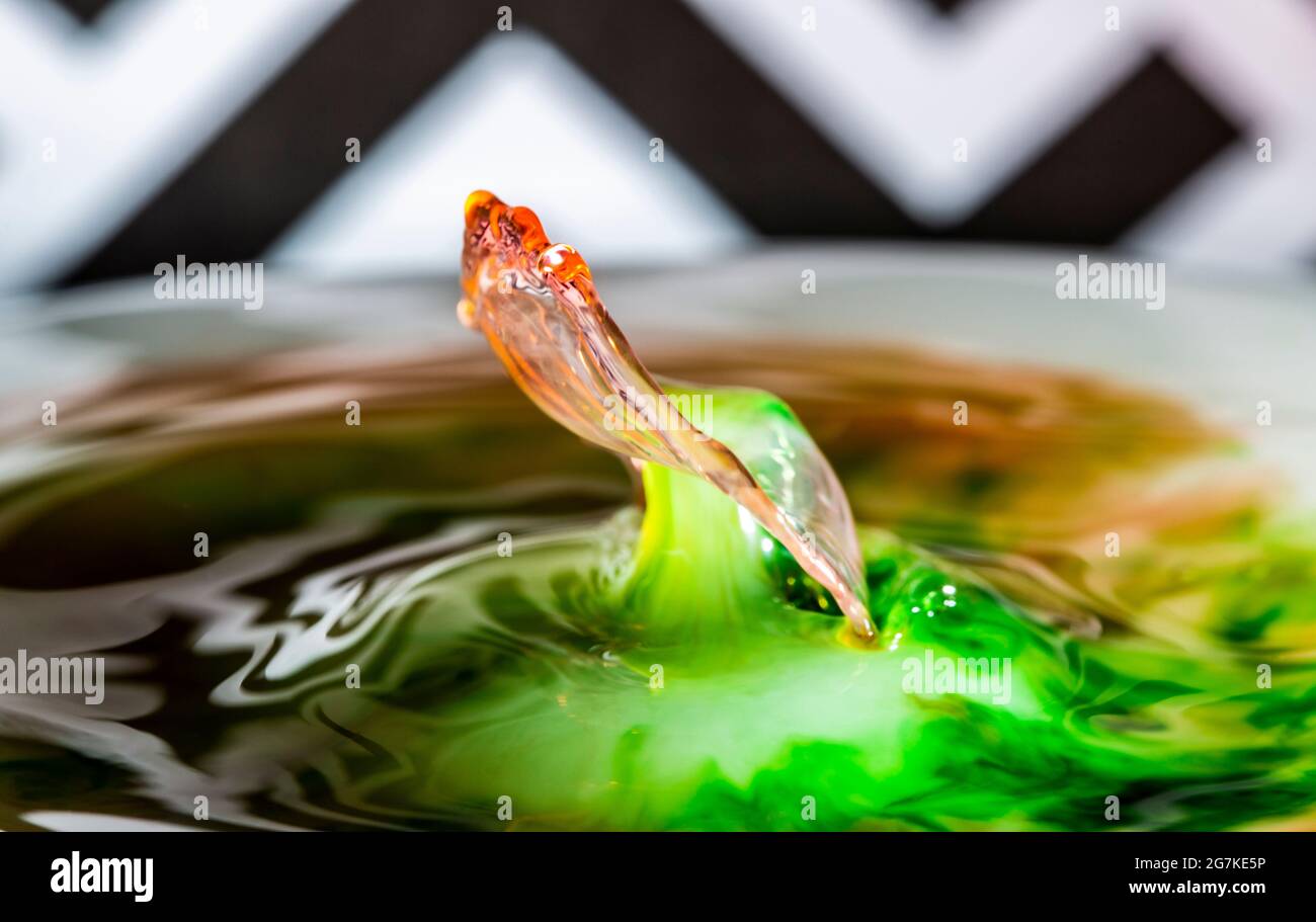 A water drop rebounding from a pool of water to create a beautiful ...