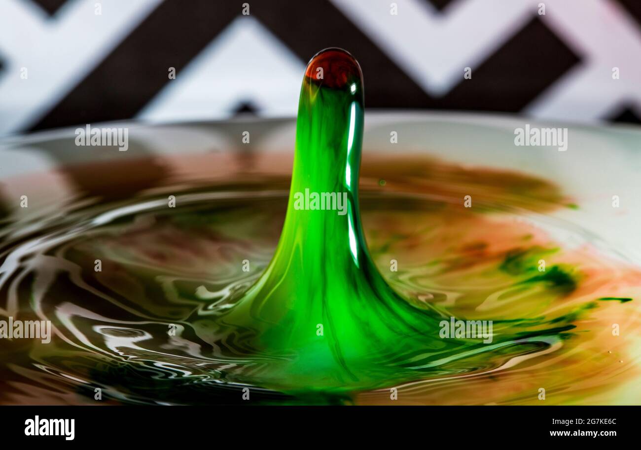 A water drop rebounding from a pool of water to create a beautiful ...