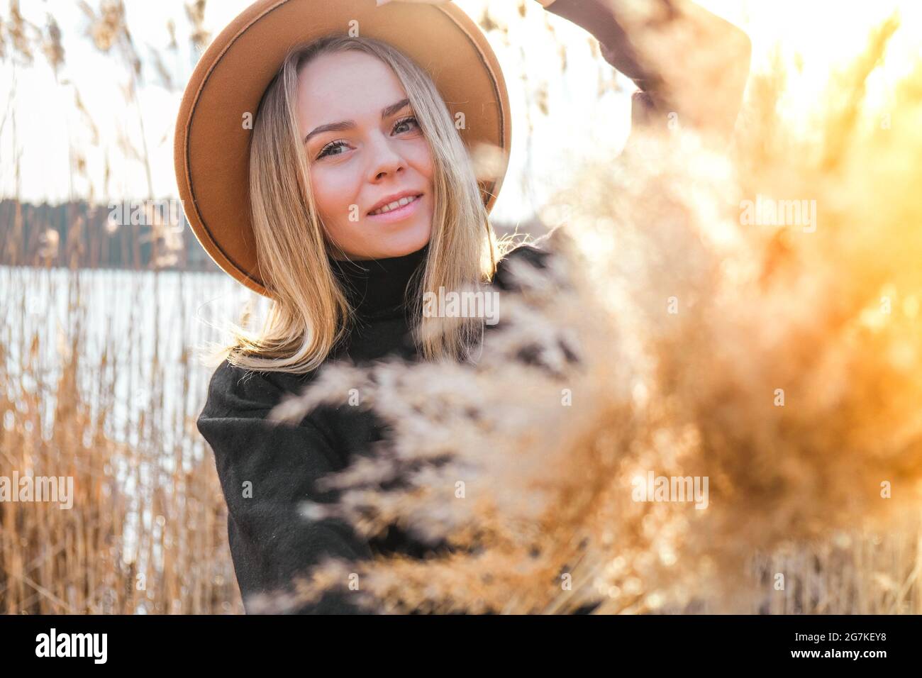 European blonde woman with beige hat in black sweater in the ...