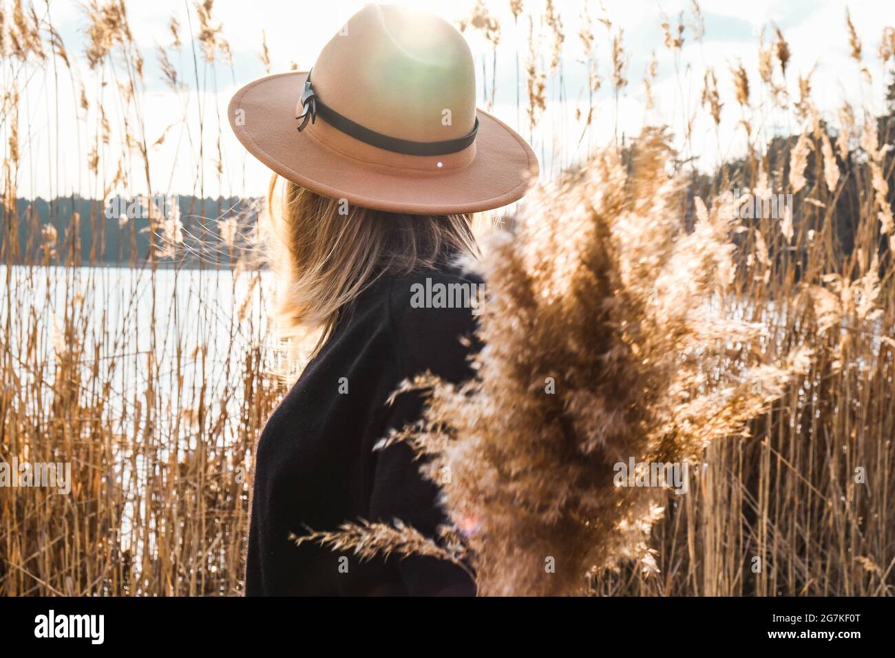 European blonde woman with beige hat in black sweater in the ...