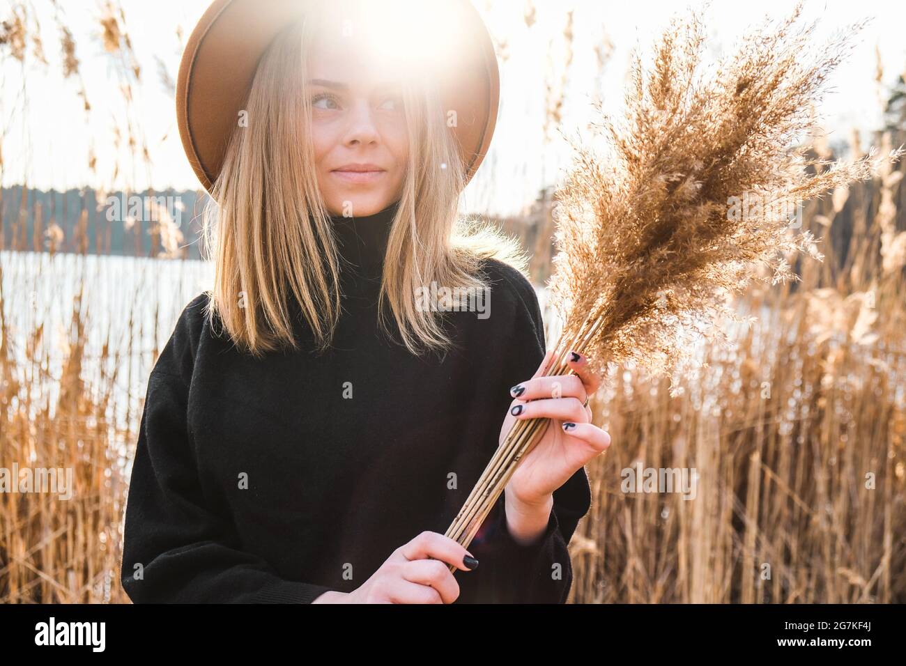European blonde woman with beige hat in black sweater in the ...