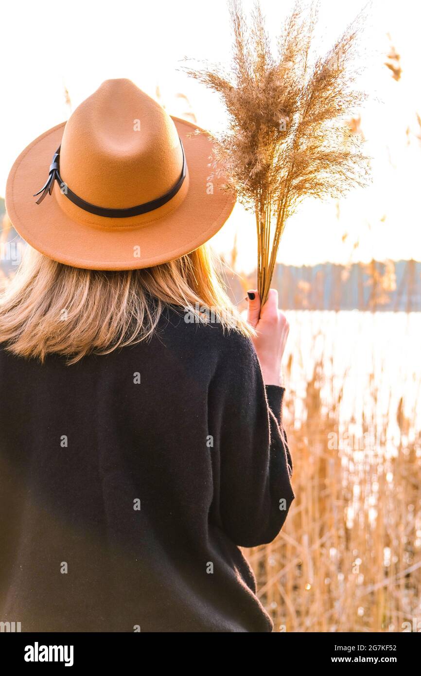 European blonde woman with beige hat in black sweater in the ...
