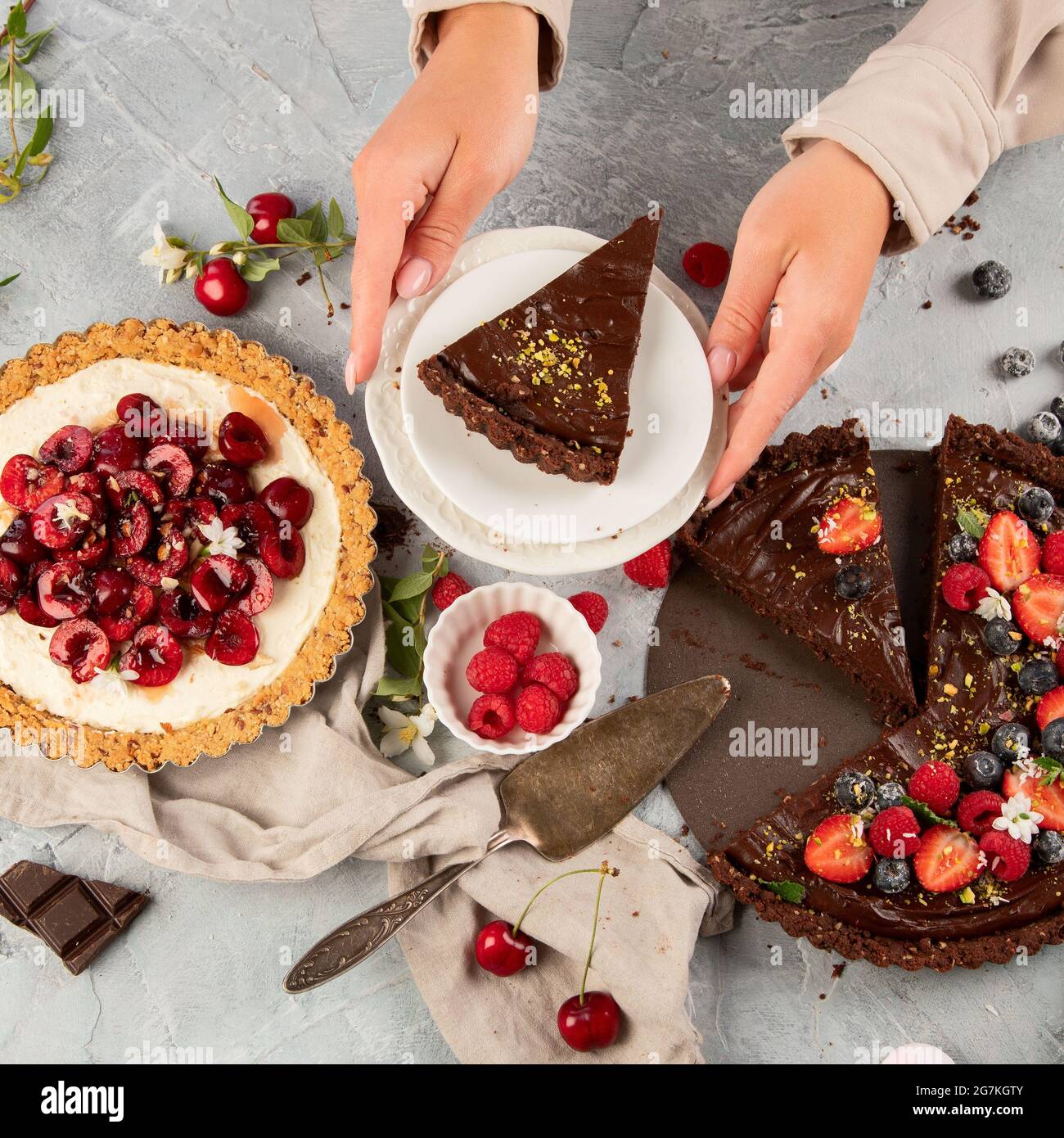 Different types of homemade tarts on light gray background. Top view ...