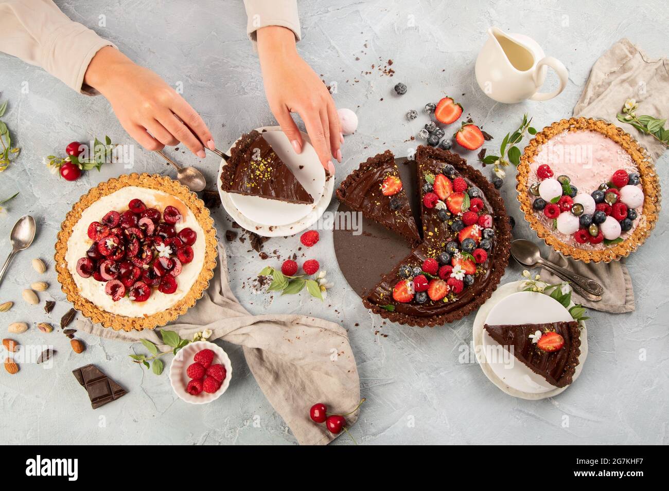 Different types of homemade tarts on light gray background. Top view ...