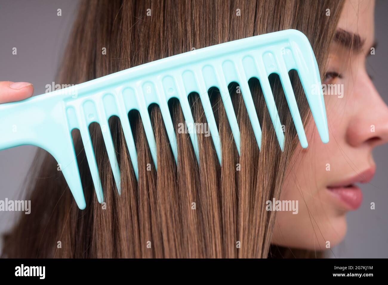 Close up woman combing hair. Macro hair comb combs hair. Haircare ...