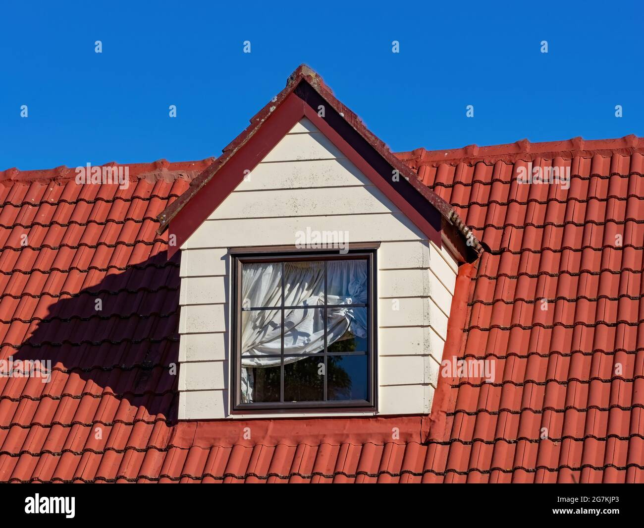 pitched roof dormer loft with white window and red concrete tile Stock ...