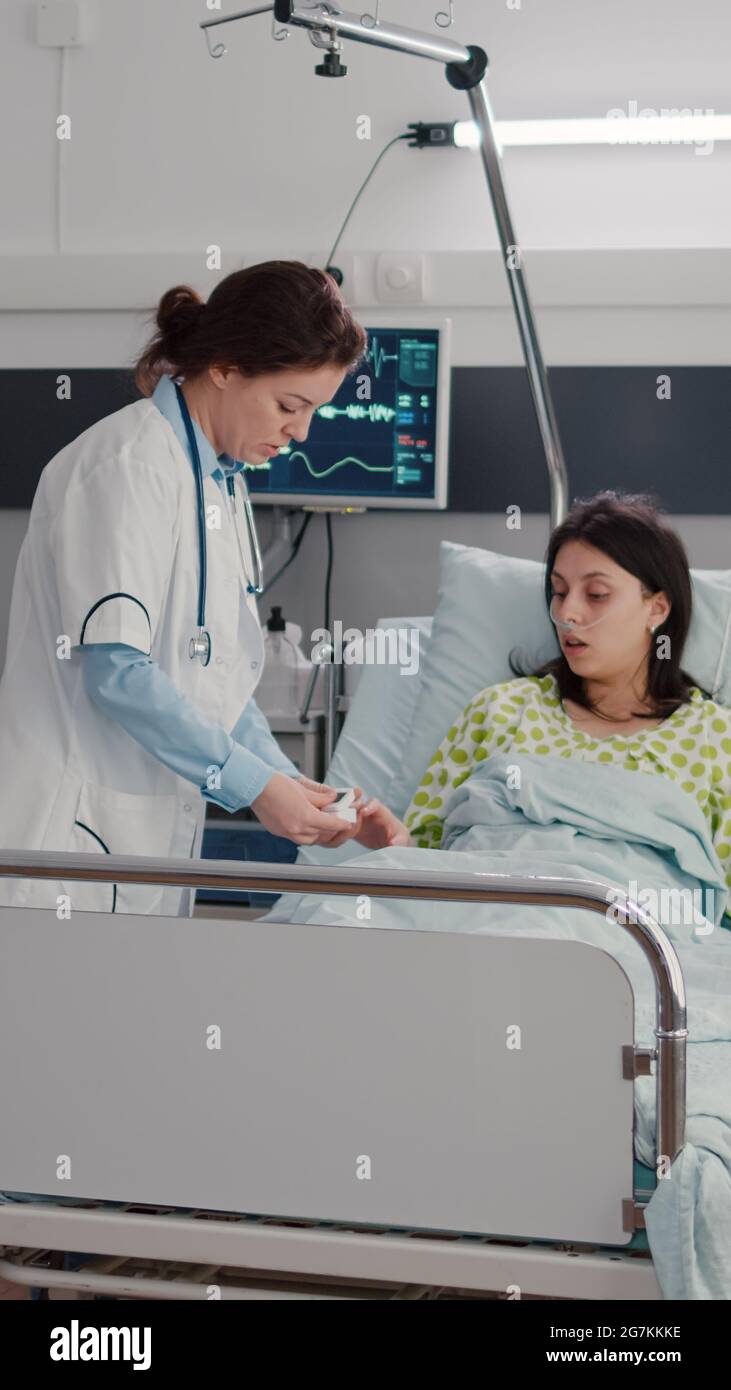 Woman doctor monitoring sick woman during rehabilitation appointment in ...