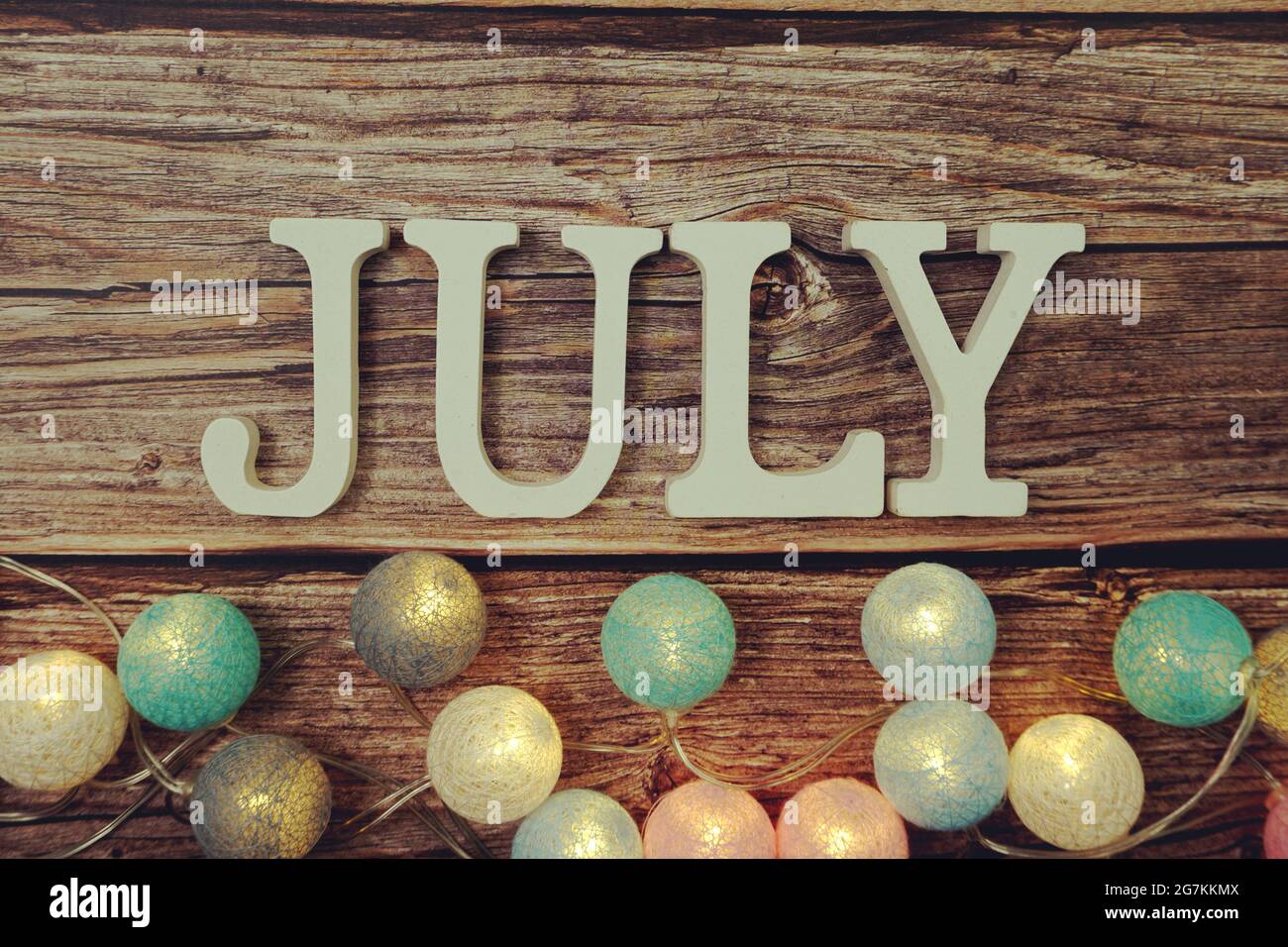 August alphabet letter with LED cotton balls on wooden background Stock ...