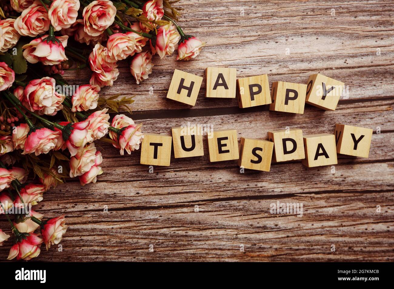 Happy Tuesday alphabet letters with flower decoration on wooden ...