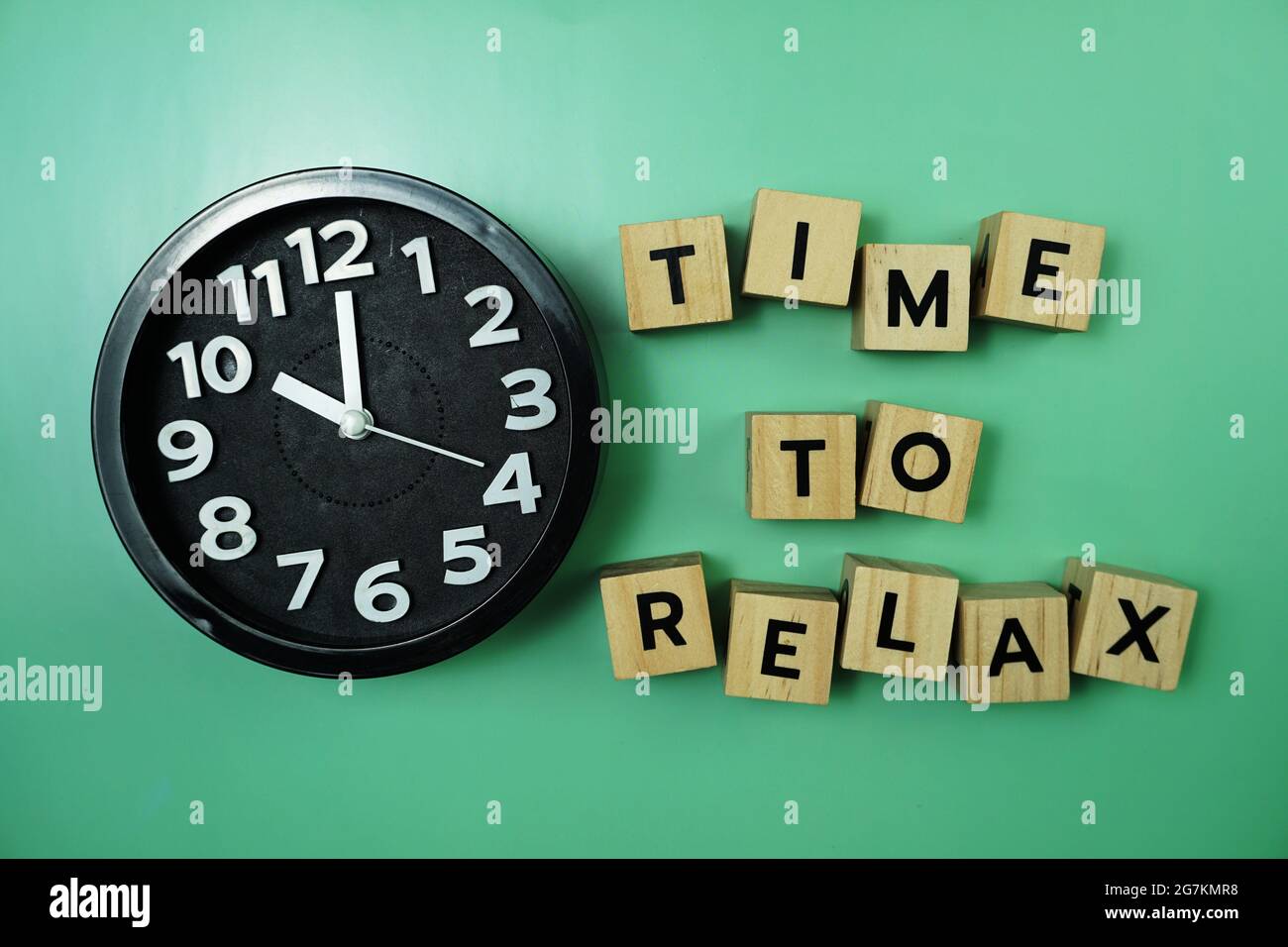 Time To Relax alphabet letter with alarm clock on wooden background ...