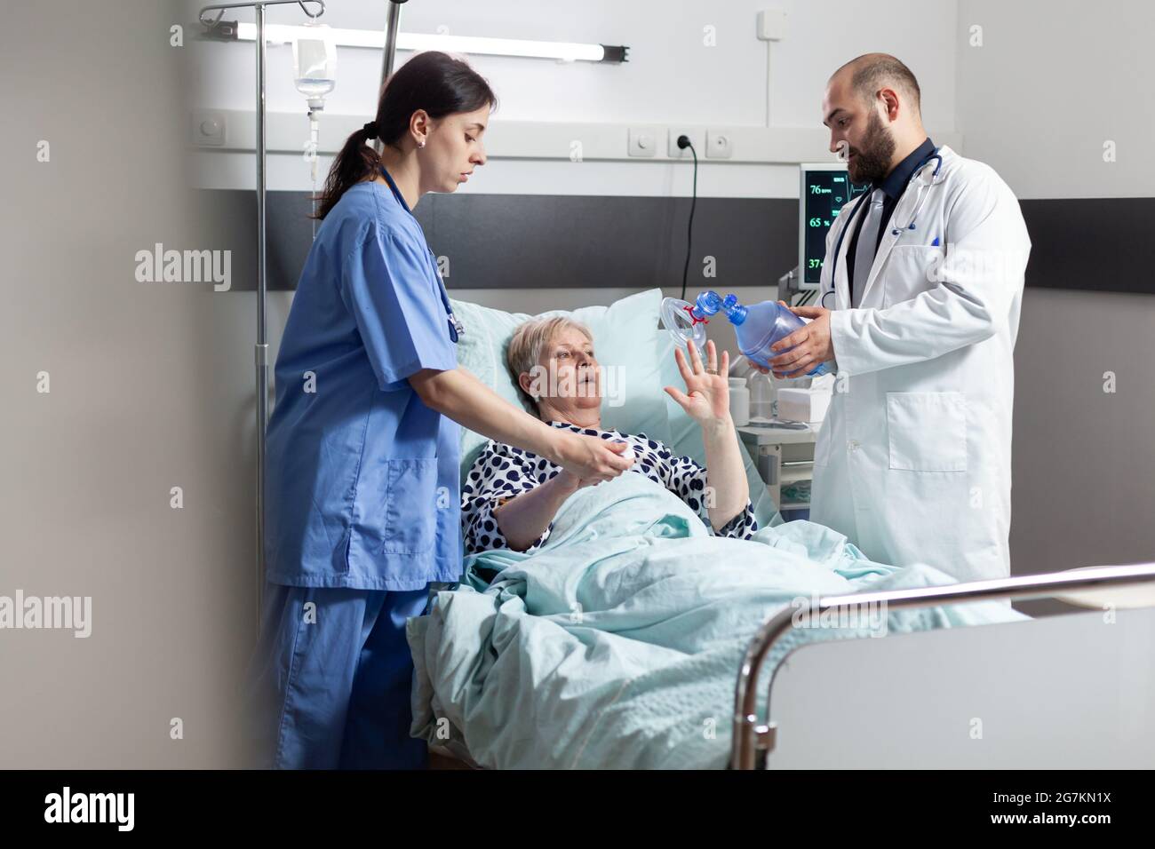 Doctor and medical nurse rushing to help senior woman breath, in ...