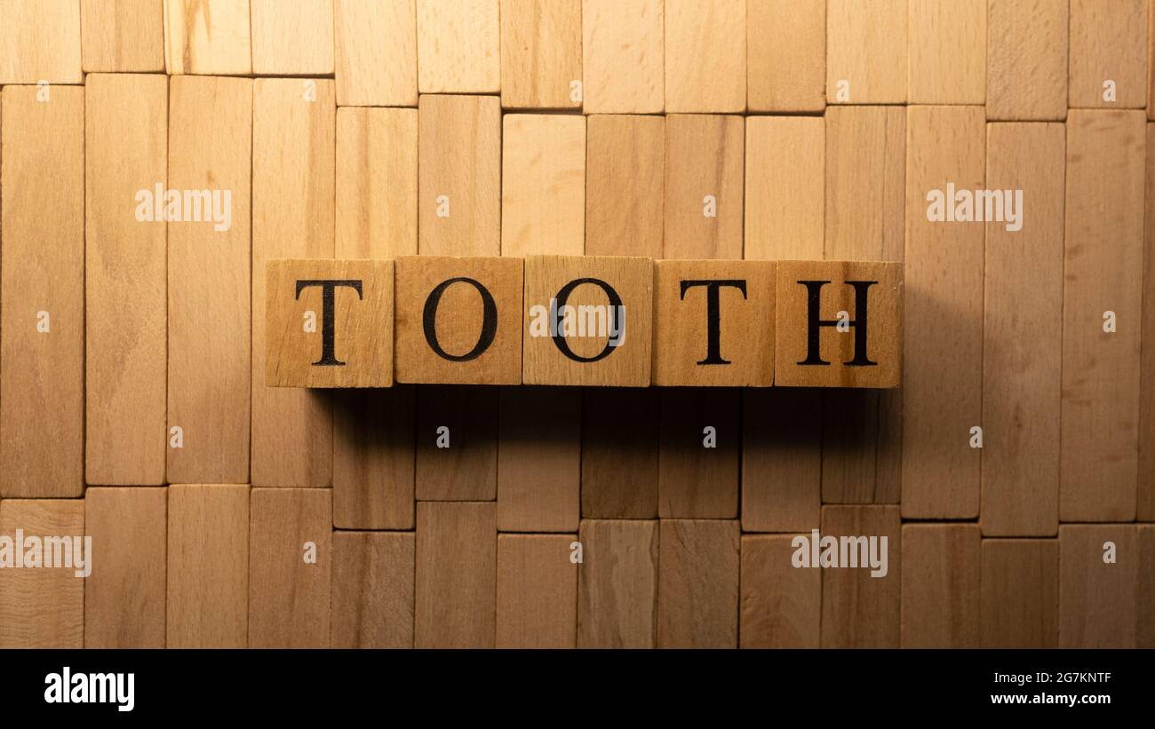 The word tooth was created from wooden letter cubes. Disease and health ...