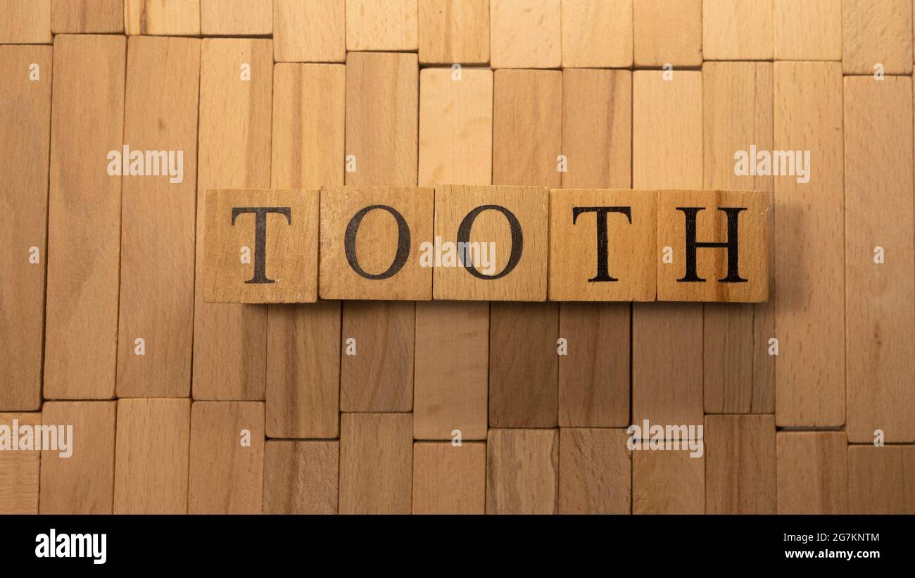 The word tooth was created from wooden letter cubes. Disease and health ...