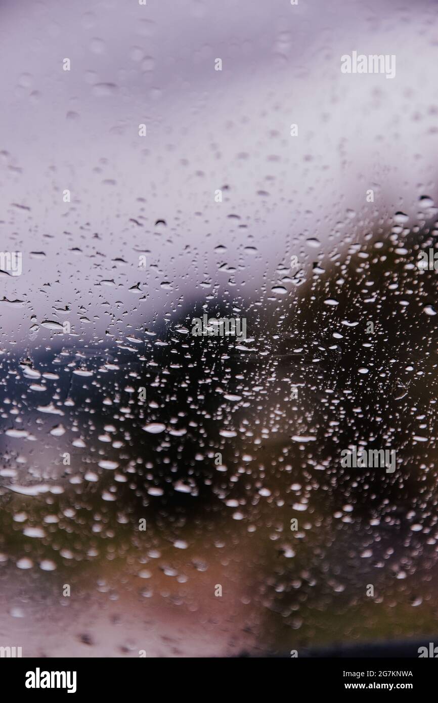 Vertical shot of a glass covered in raindrops Stock Photo - Alamy