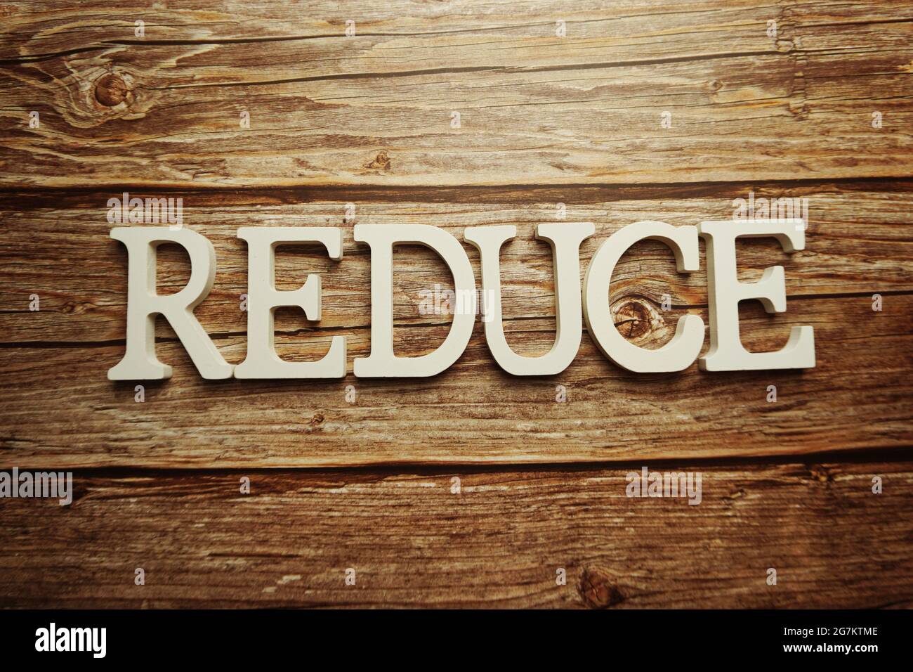 Reduce alphabet letters top view on wooden background Stock Photo - Alamy