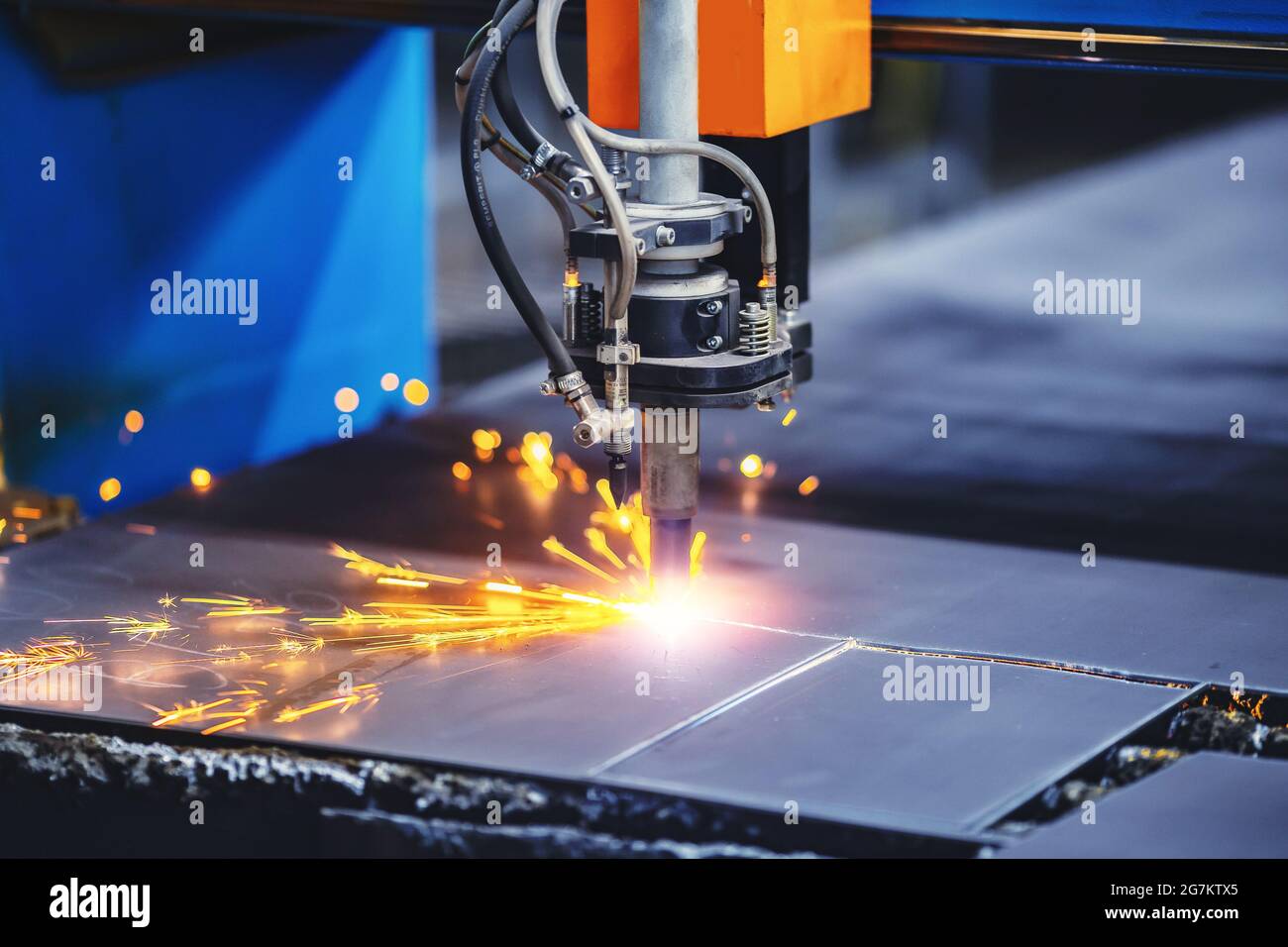 Plasma cutting CNC machine cuts metal material with sparks, industry ...