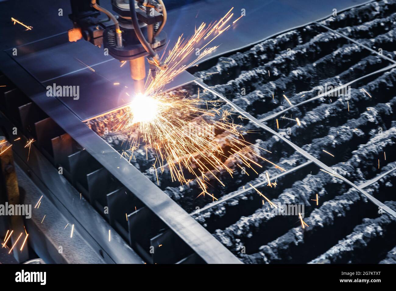 Closeup plasma cutting CNC machine cuts metal material with sparks ...