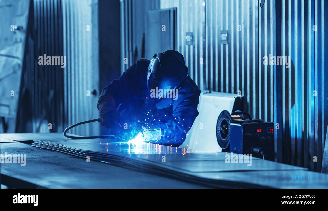 Closeup professional welder working at steel structure manufacturing ...