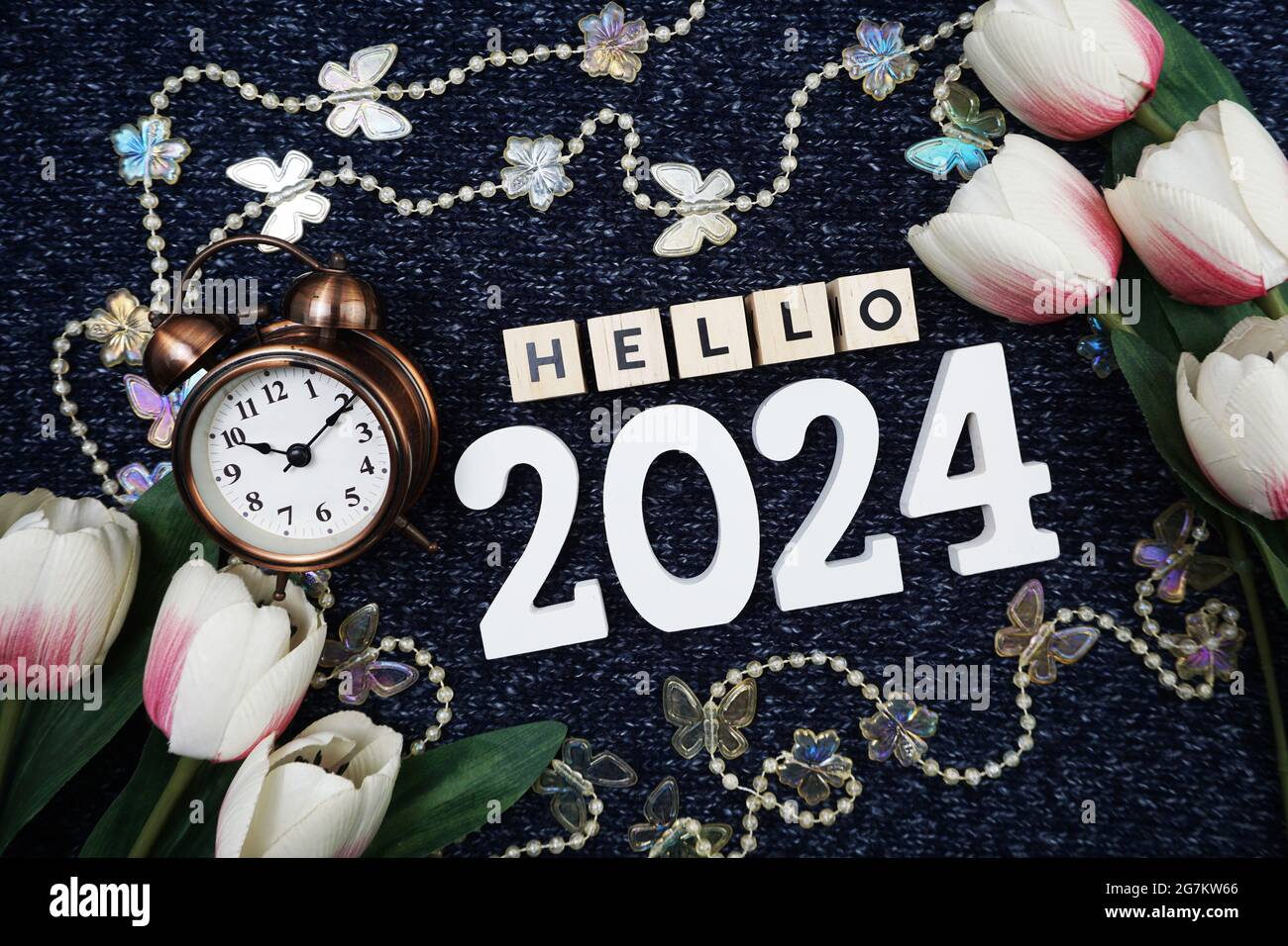 Hello 2024 alphabet letter decorate with alarm clock on blue knitted fabric background Stock ...