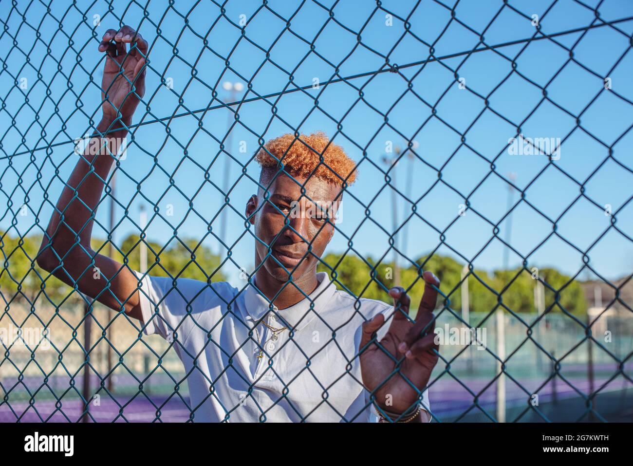 Man leaning against fence hi-res stock photography and images - Alamy