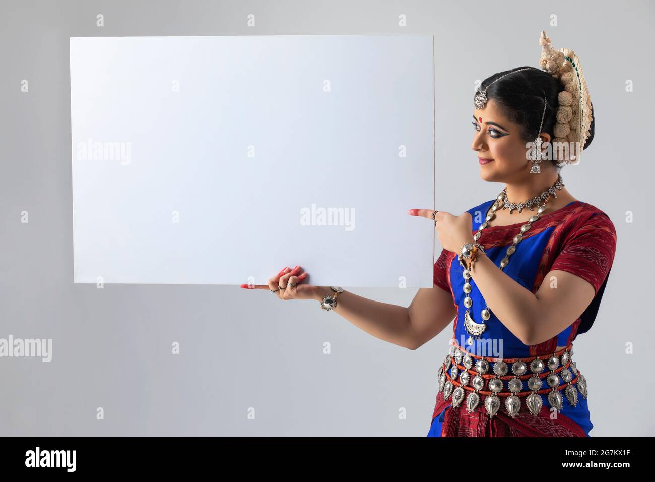 Odissi dancer pointing at blank placard Stock Photo - Alamy