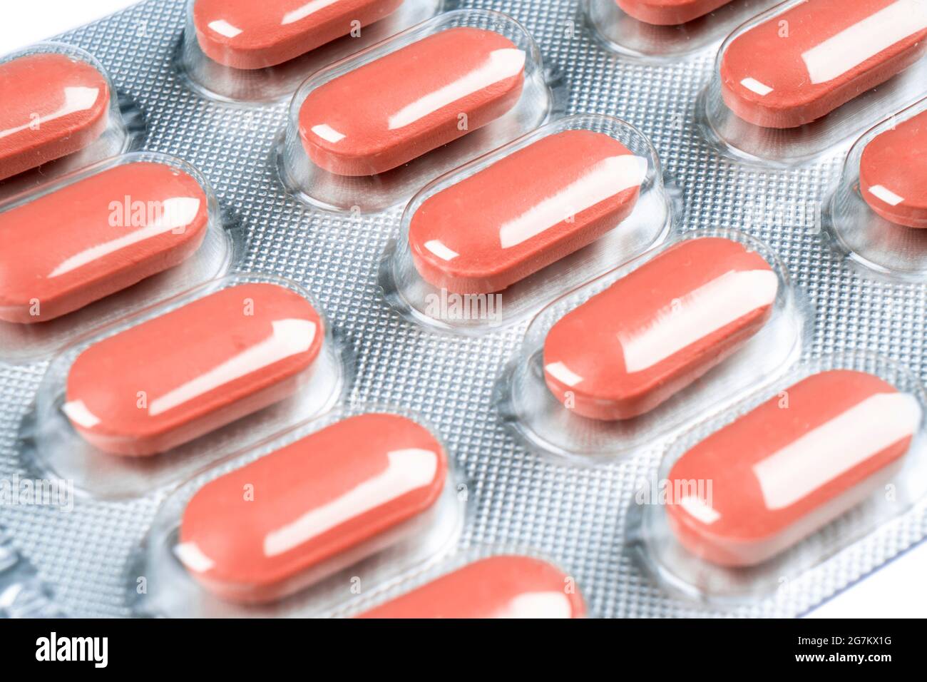 Macro shot pile of red tablets pill in blister packaging isolated on ...