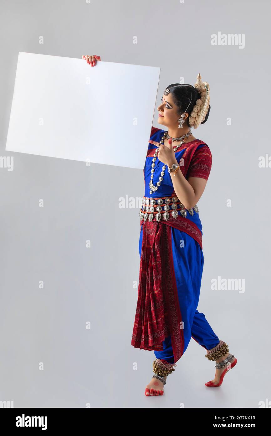 Odissi dancer pointing at blank placard Stock Photo - Alamy