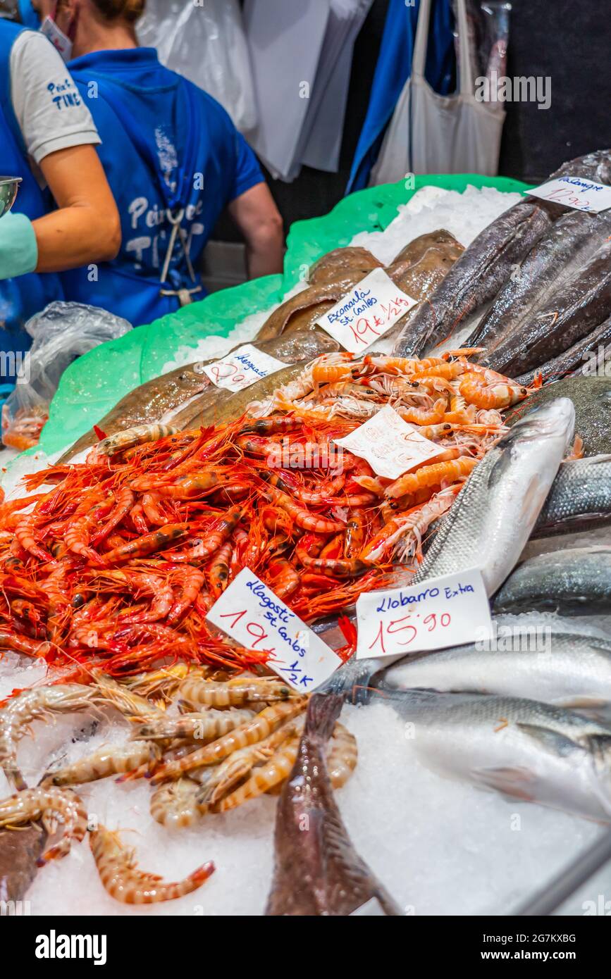 Fish and other seafood on a counter on sale at a Spanish market in ...